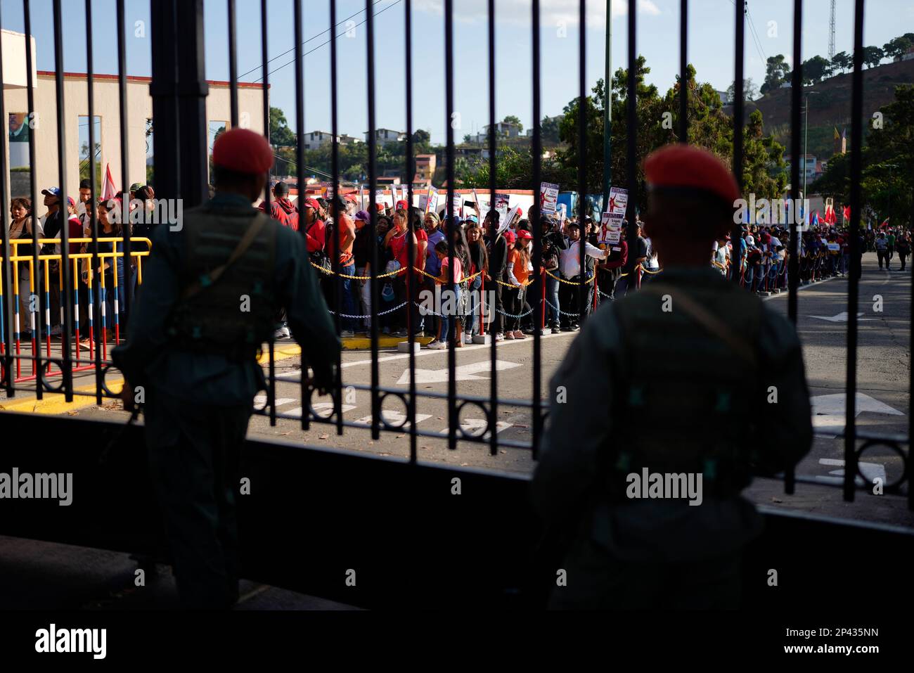 An honor guard stands at the entrance as people line up outside to ...
