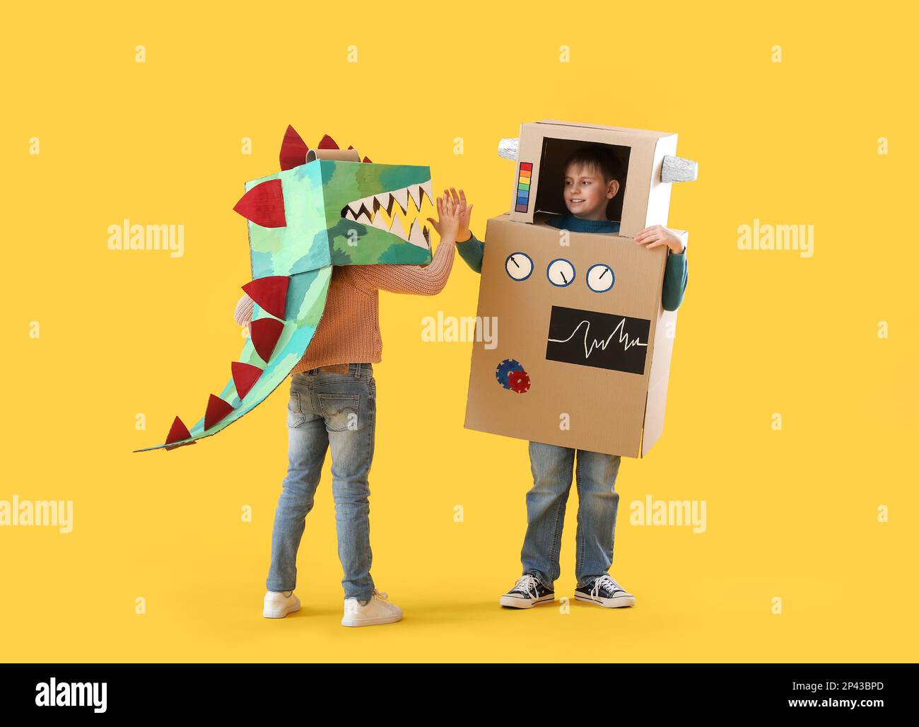 Little children in cardboard costumes giving each other high-five on ...