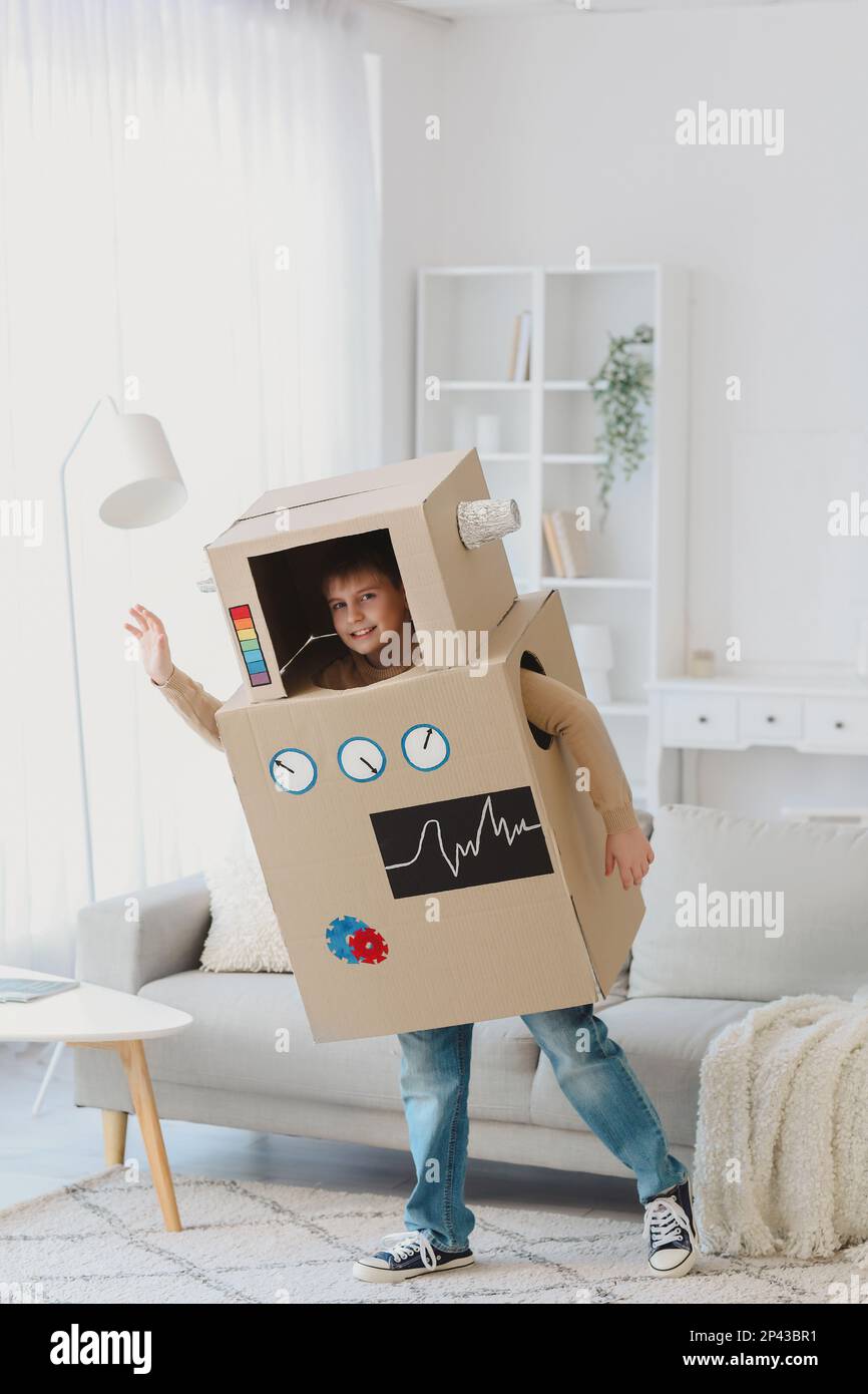 Little boy in cardboard robot costume playing at home Stock Photo - Alamy
