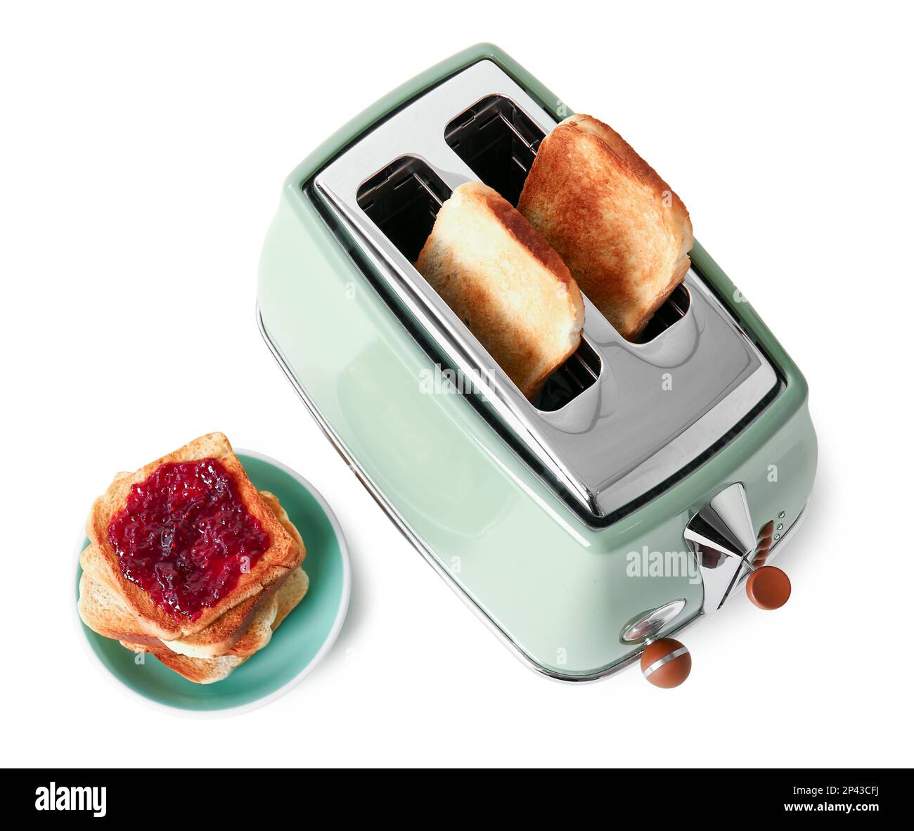 Bread slices in modern toaster and tasty toasts with jam on beige background Stock Photo - Alamy