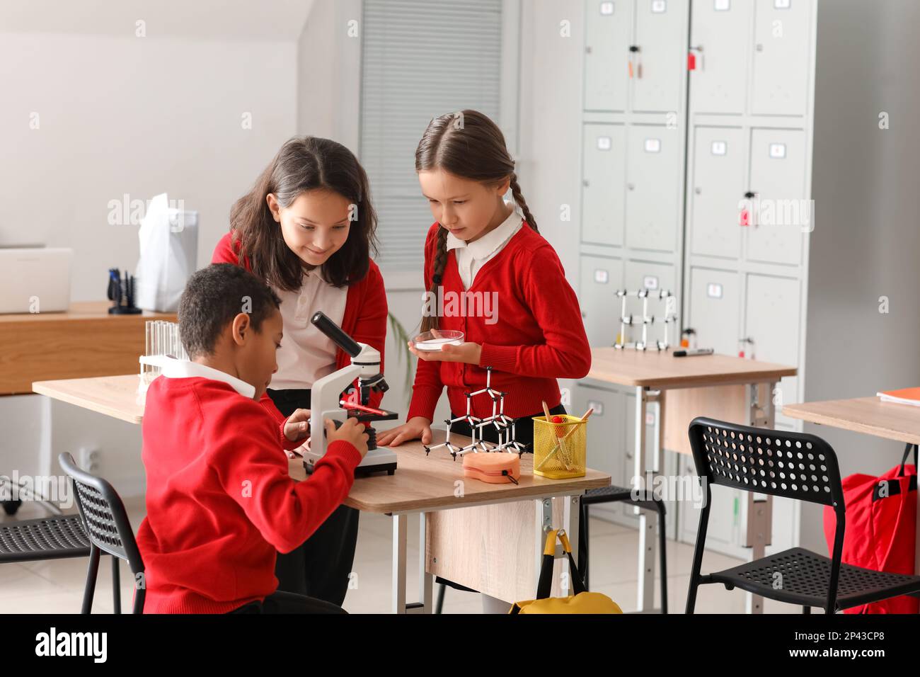 Little children with microscope having Chemistry lesson in science ...