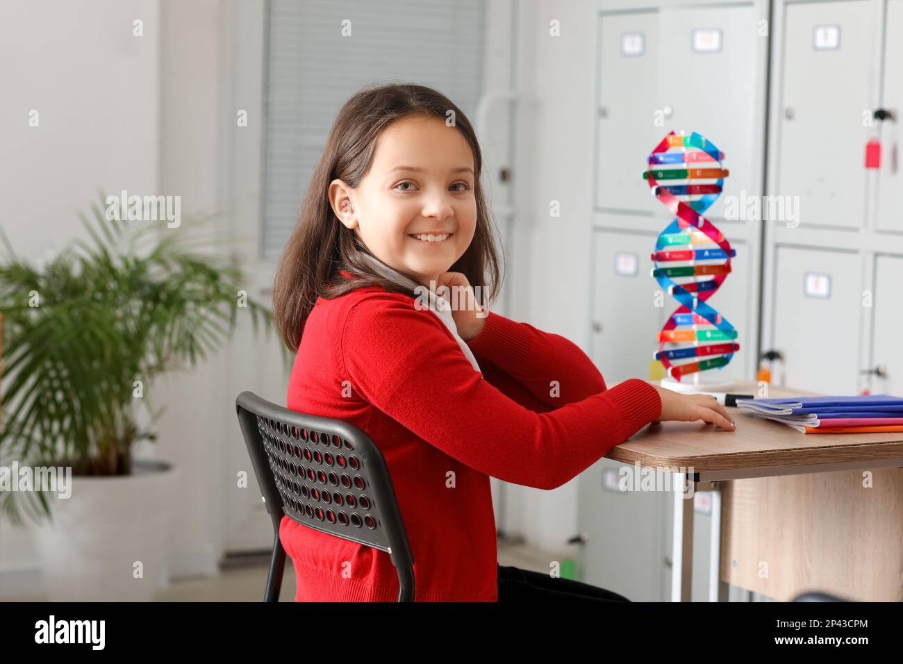 Little girl with molecular model having Chemistry lesson in science ...