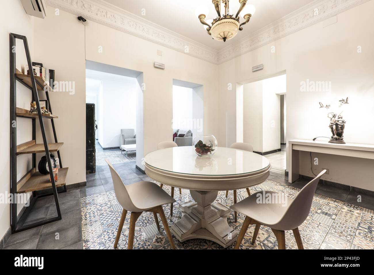 Dining room of a house with hydraulic tile floors with a white wooden ...