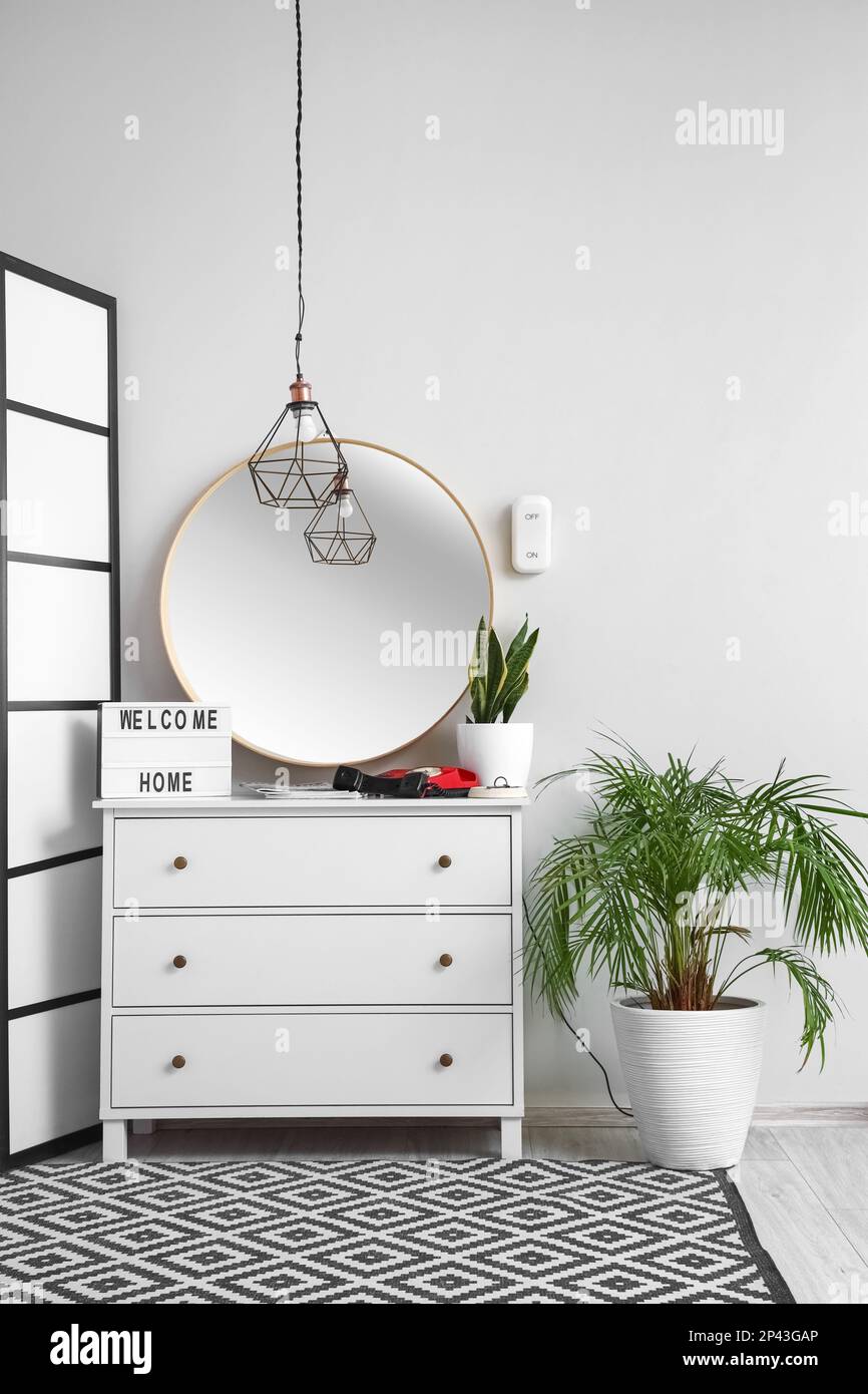 Interior of light hall with commode and mirror Stock Photo - Alamy