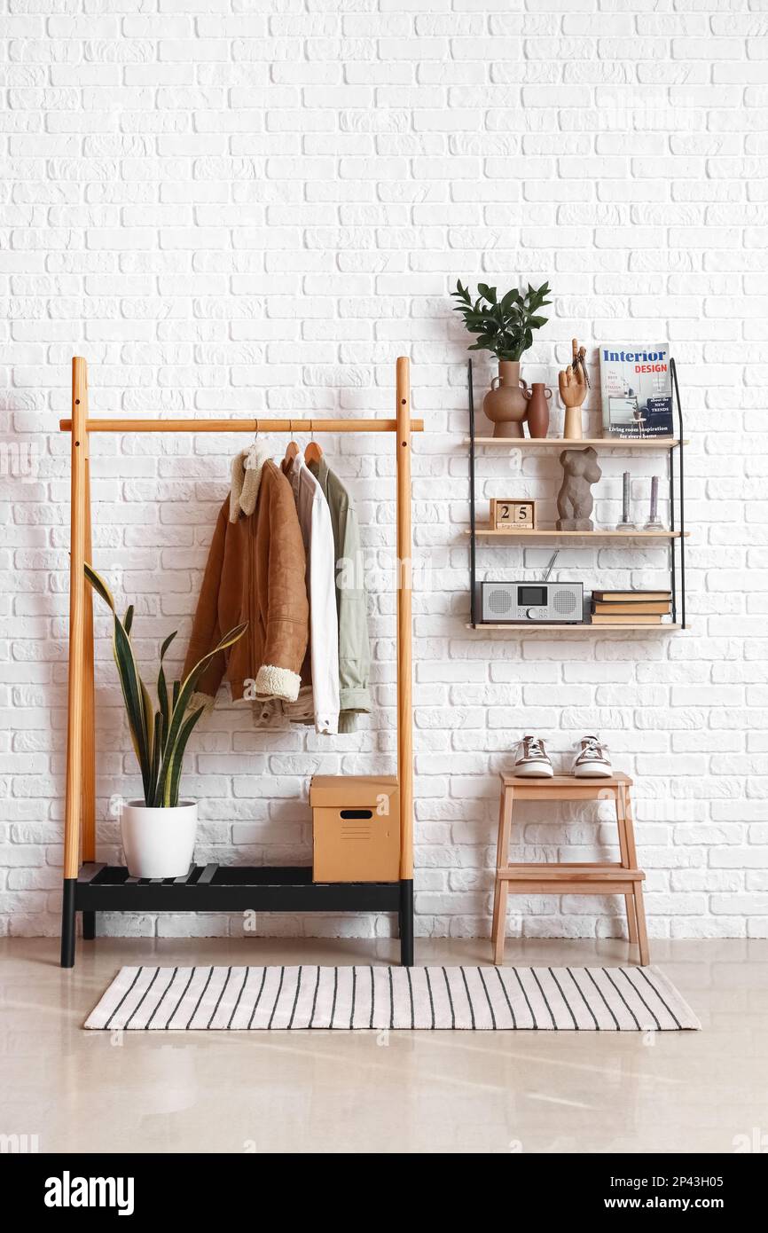 Interior of stylish hall with rack and shelf Stock Photo - Alamy