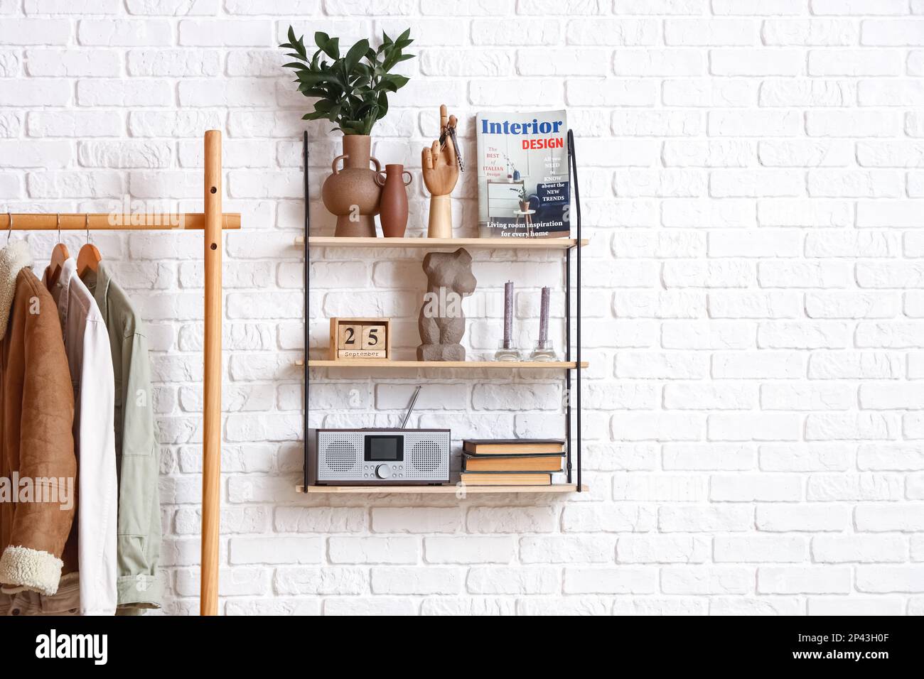 Interior of stylish hall with rack and shelf Stock Photo - Alamy