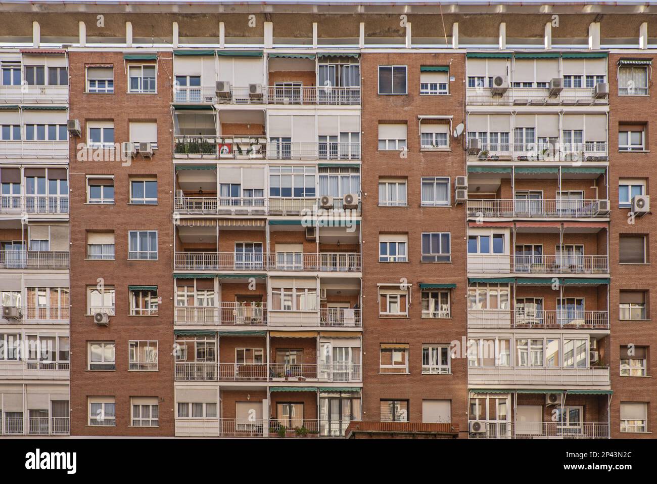 Facades of beehive-type urban residential buildings with balconies and ...