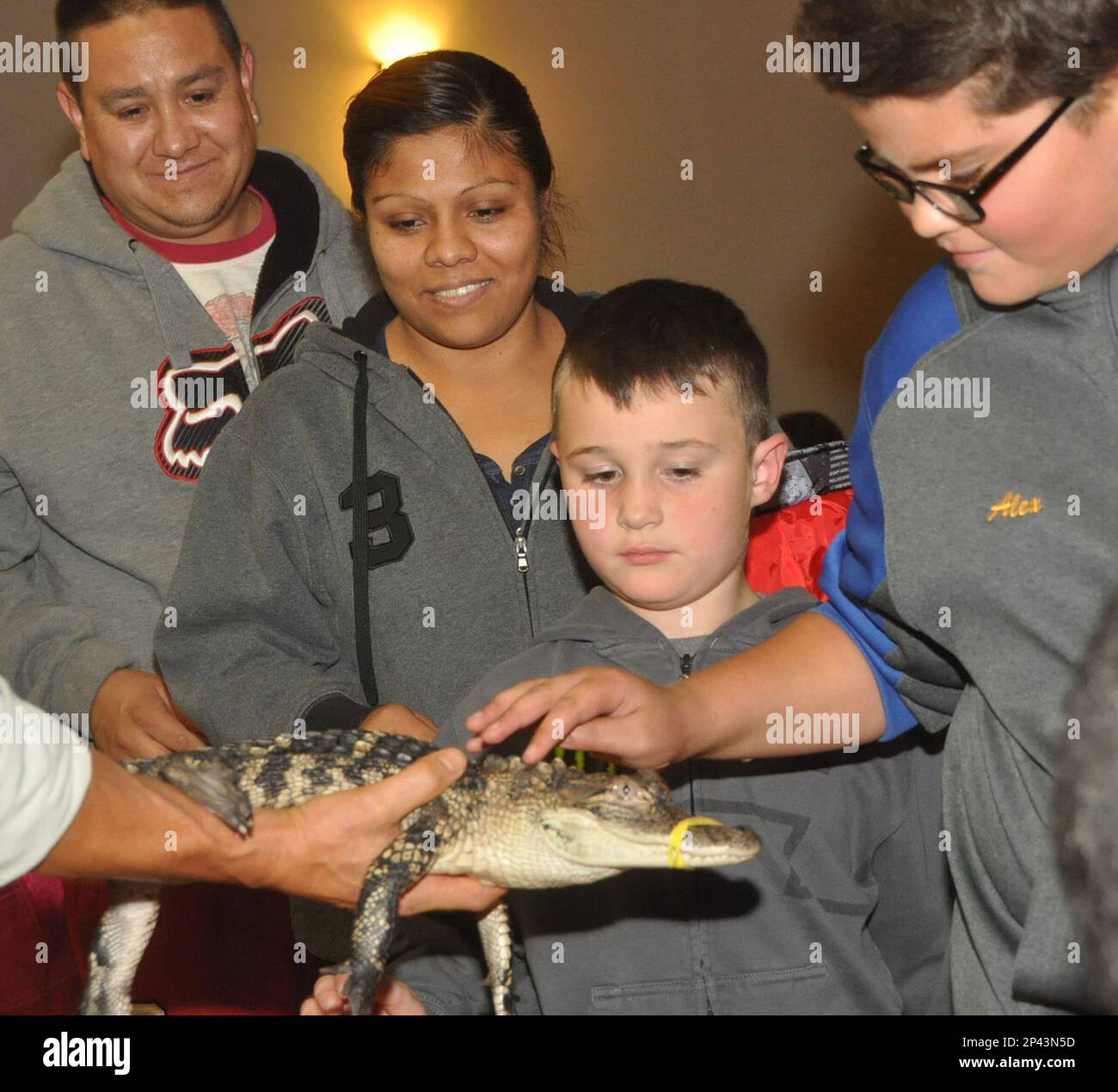 In this photo taken on Monday, Oct. 20, 2014, children and adults touch ...