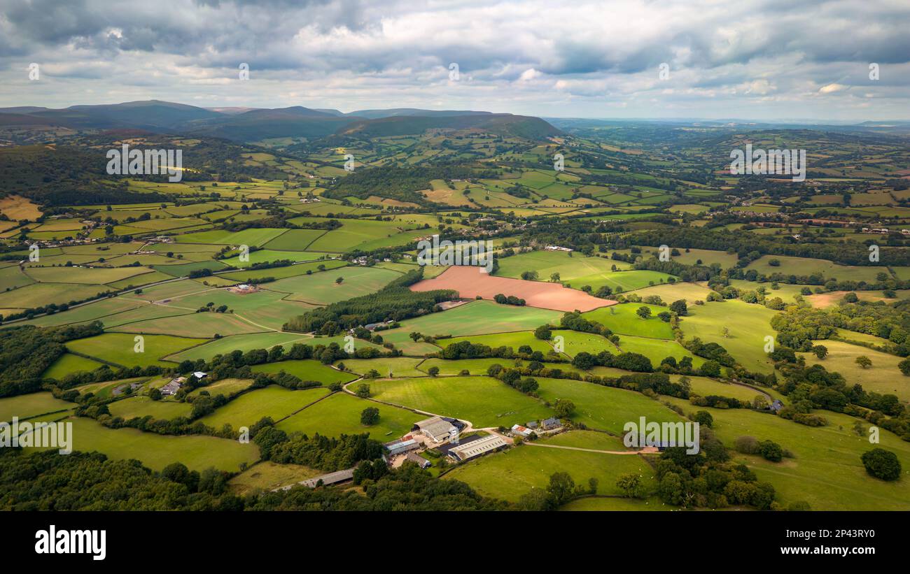 Aerial view of rural farmland and fields in a hilly area (South Wales ...