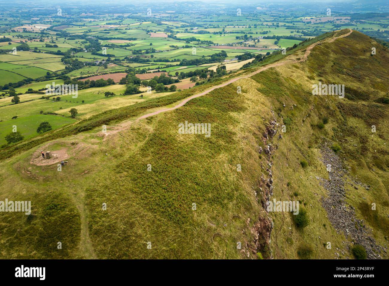 Aerial view of the summit of a small mountain surrounded by farmland ...