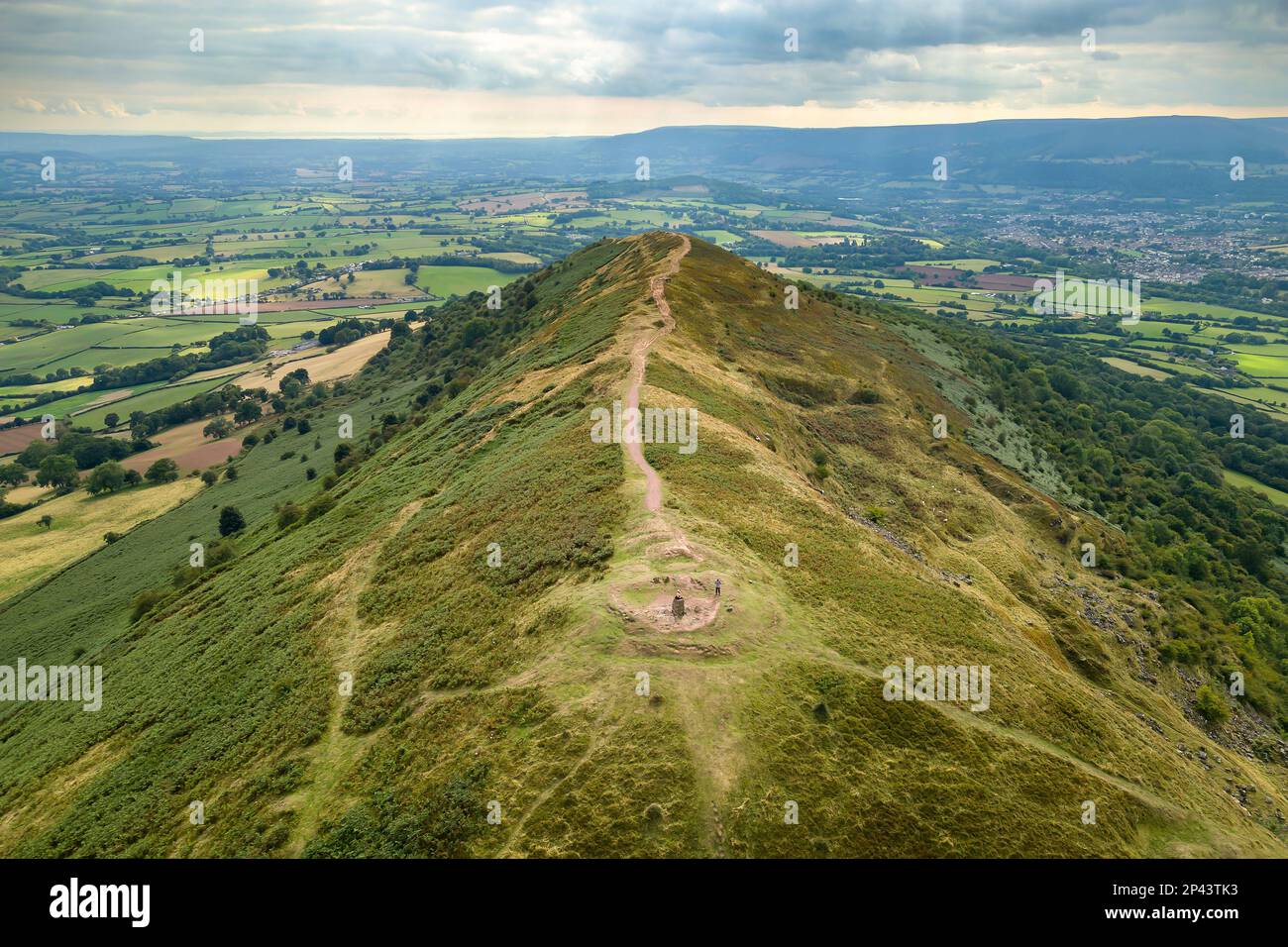 Aerial view of the summit of a small mountain surrounded by farmland ...