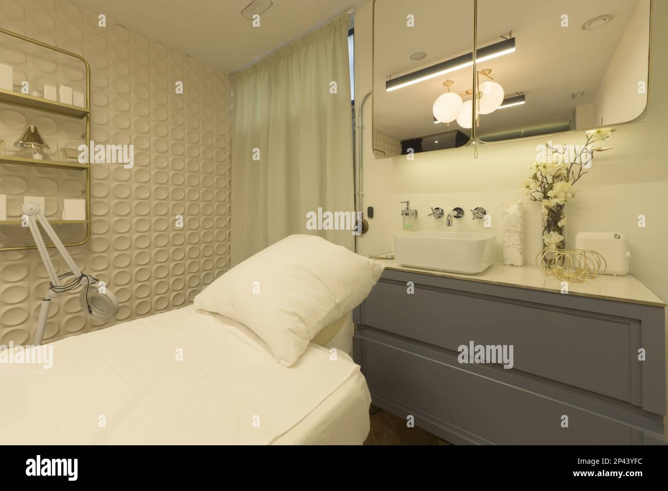 Aesthetic treatment room with a relaxation table, creams and appliances ...