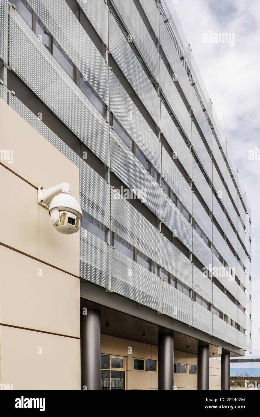 office building facades with large windows, a porch on the ground floor ...
