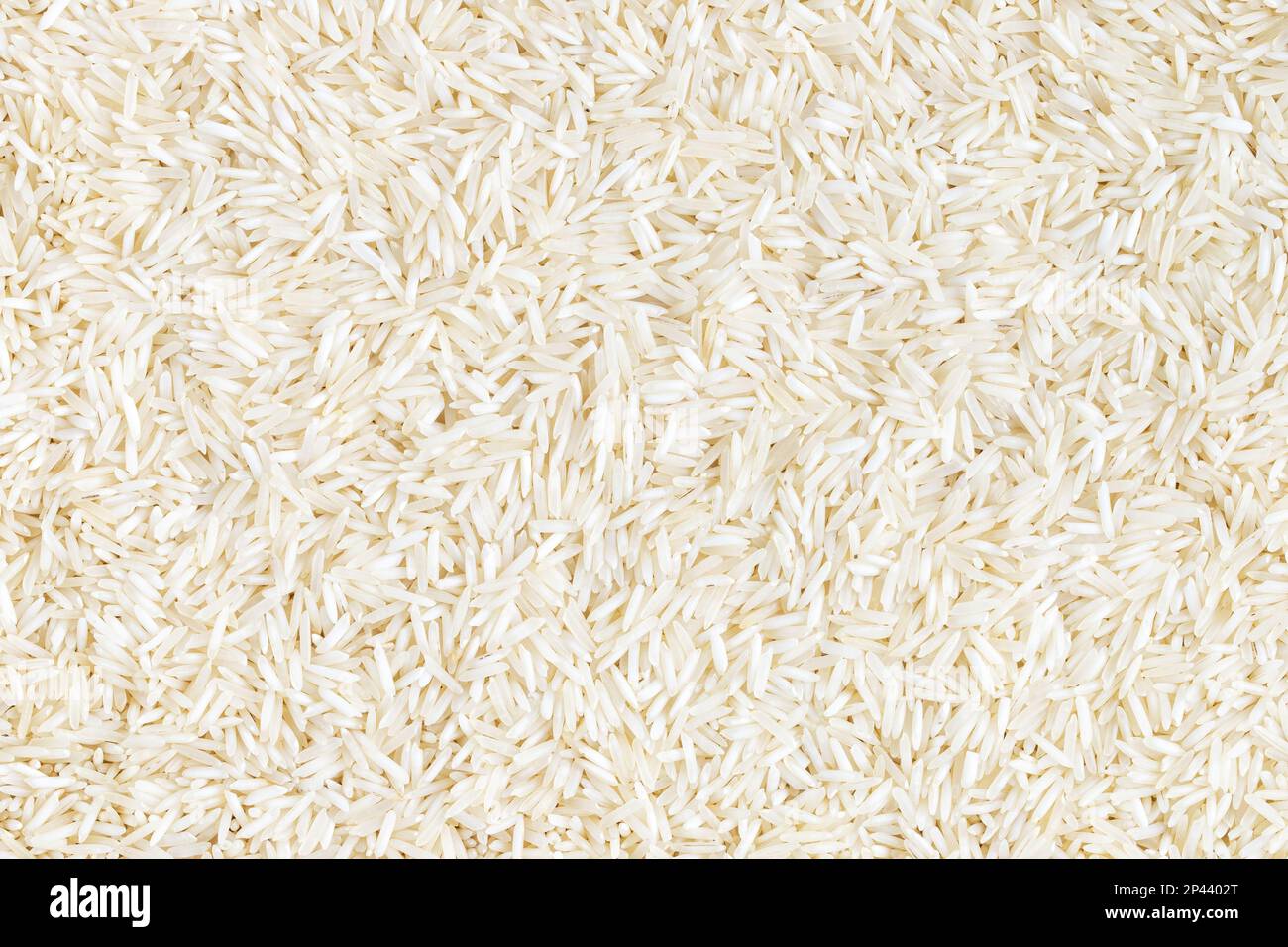 Basmati long white rice background, full frame Stock Photo - Alamy
