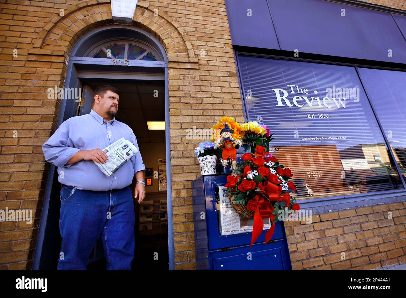 Todd Brooks stands in the doorway of the offices of the Marlow Review ...