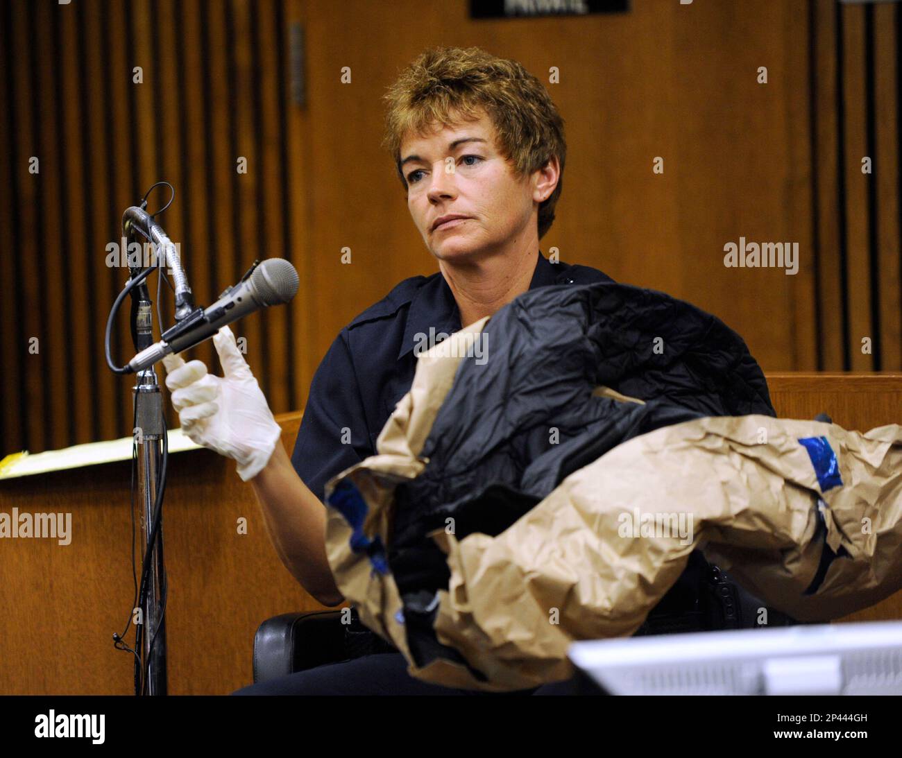 Detroit Police office Lori Briggs, a evidence technician, shows photos ...