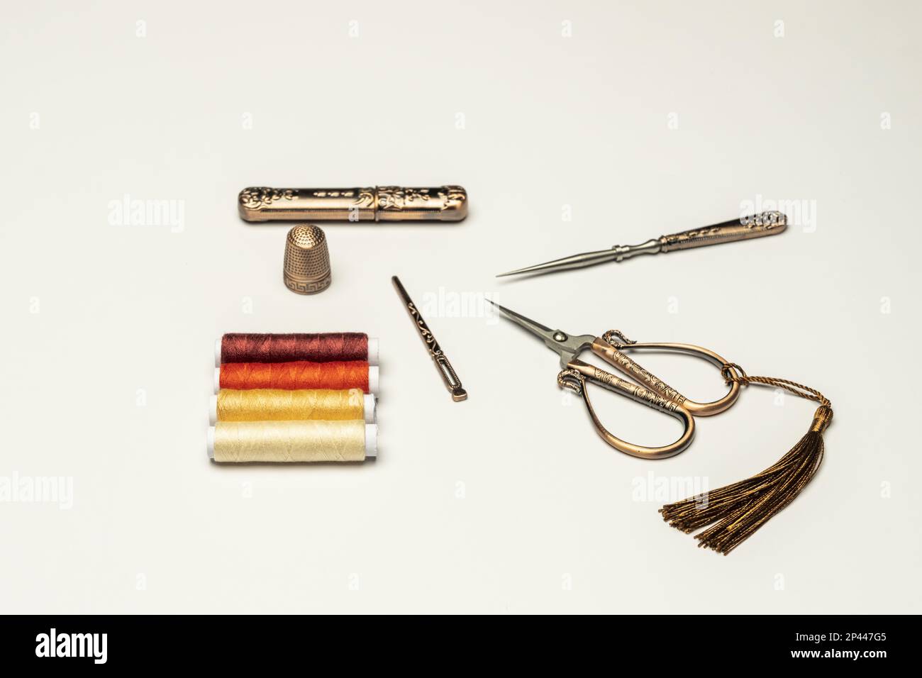 A set of old style copper scissors, thimbles and sewing accessories ...