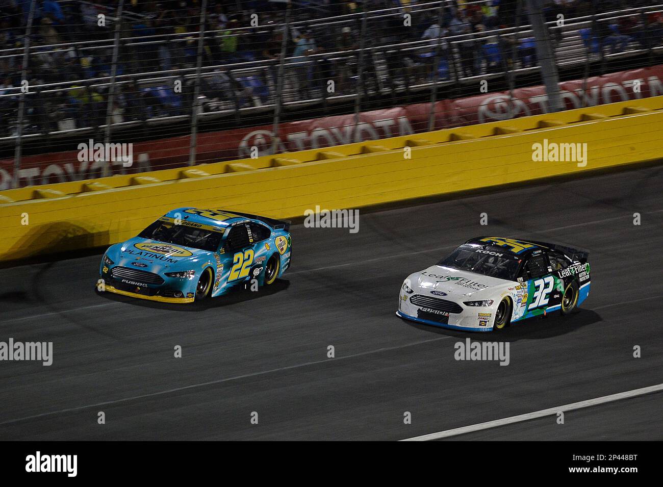CHARLOTTE, NC - OCTOBER 11: Joey Logano (22) races with Blake Koch (32 ...