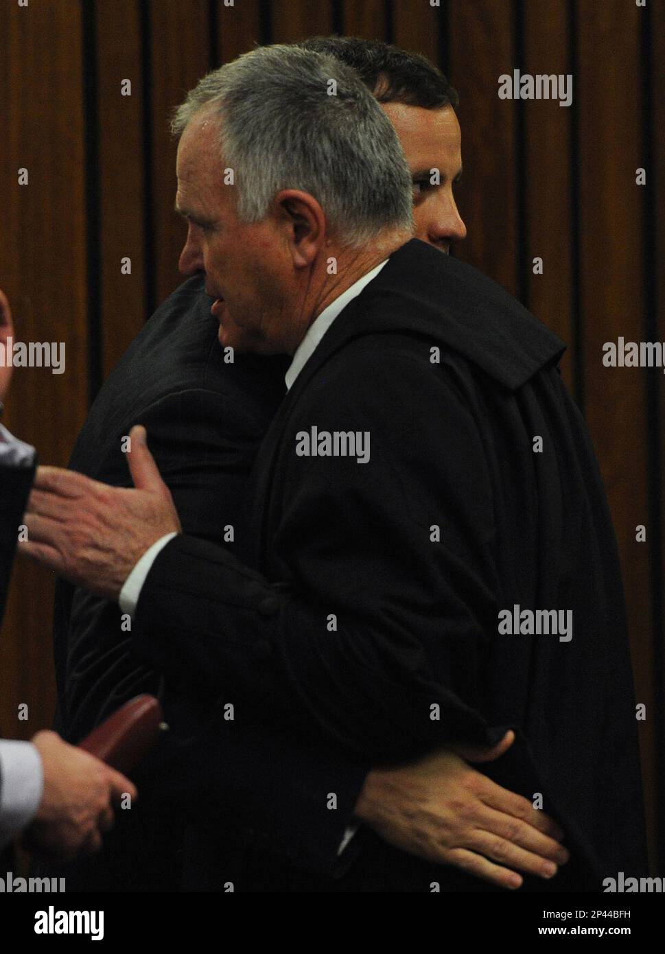 Oscar Pistorius, with his defense lawyer, Barry Roux, front, in court ...