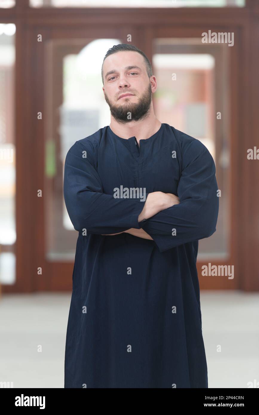 Portrait of a Adult Muslim Man Is Praying In The Mosque While Wearing A ...