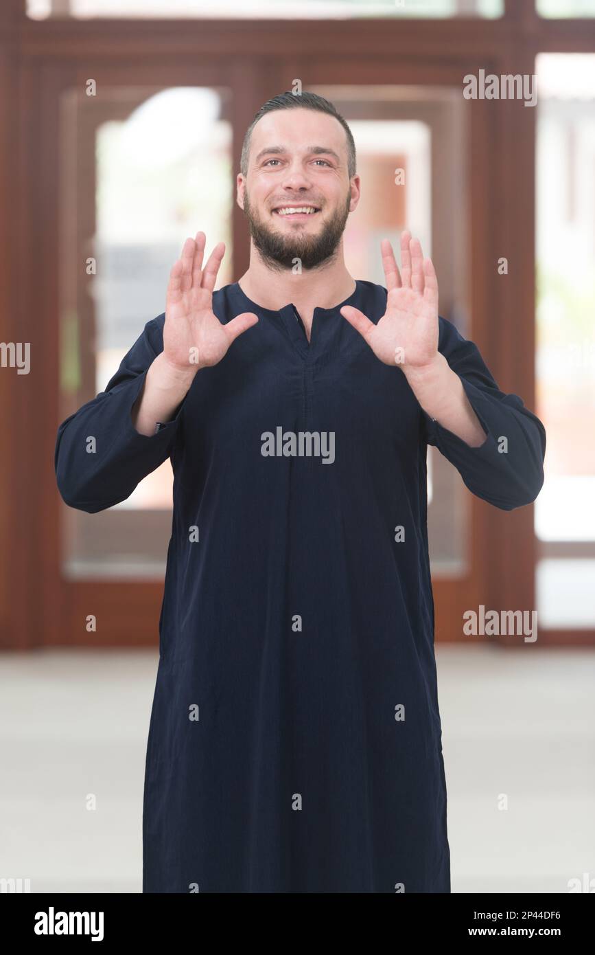 Young Muslim Man Making Traditional Prayer To God Allah While Wearing A ...