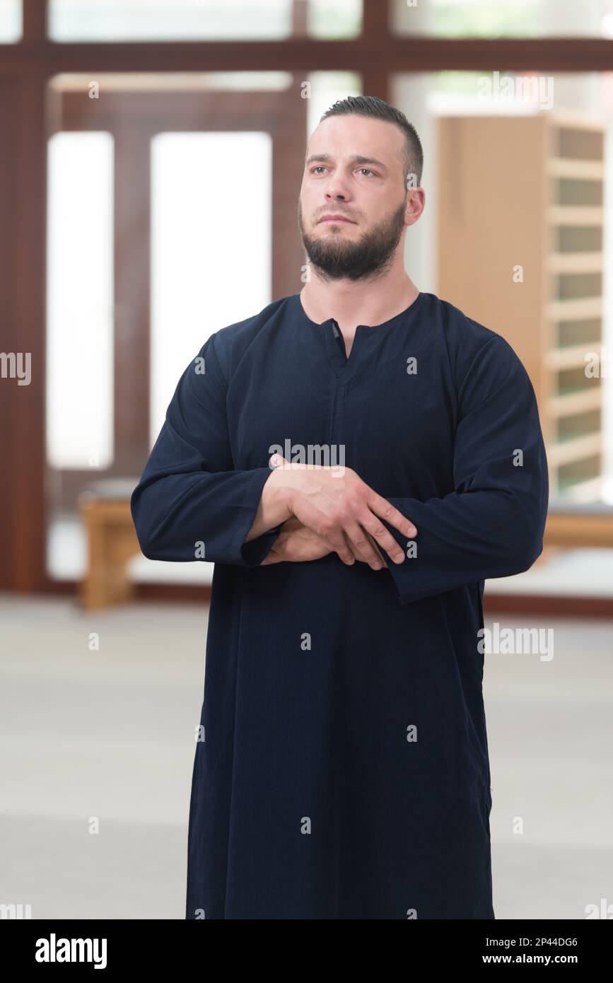 Young Muslim Man Making Traditional Prayer To God While Wearing A ...