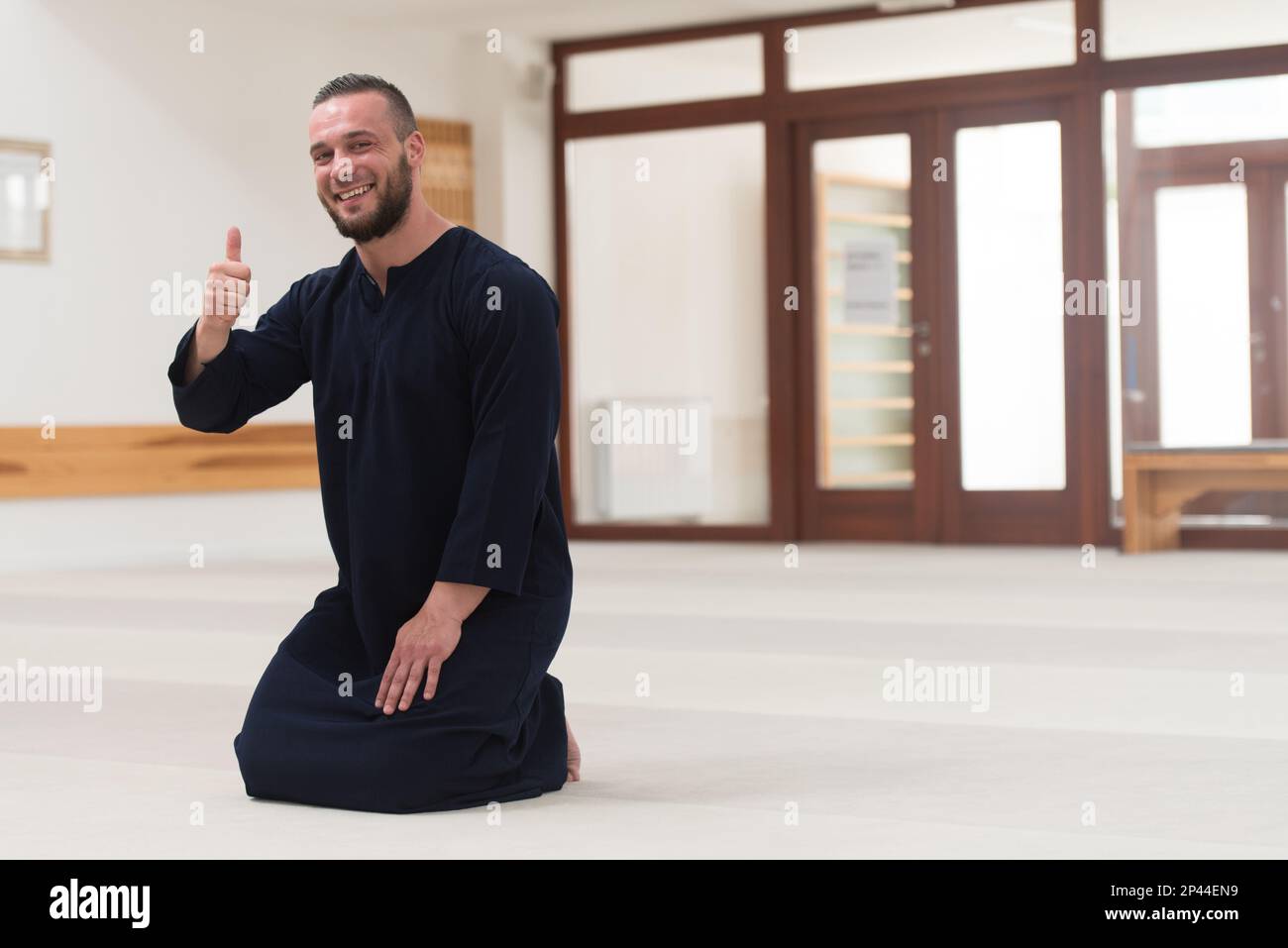 Young Muslim Man Making Traditional Prayer To God While Wearing A ...