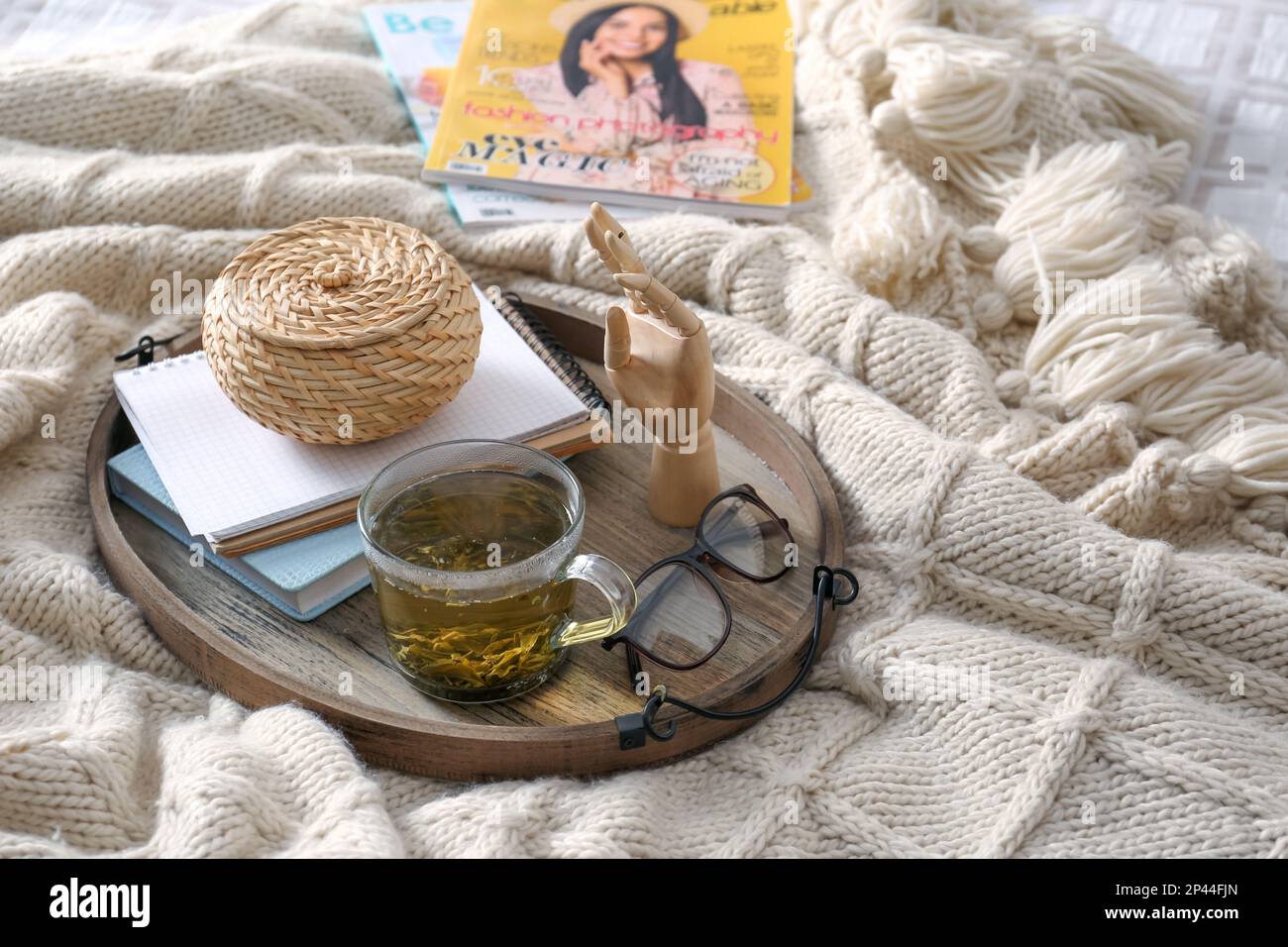 Stylish tray with different interior elements and tea on bed Stock ...