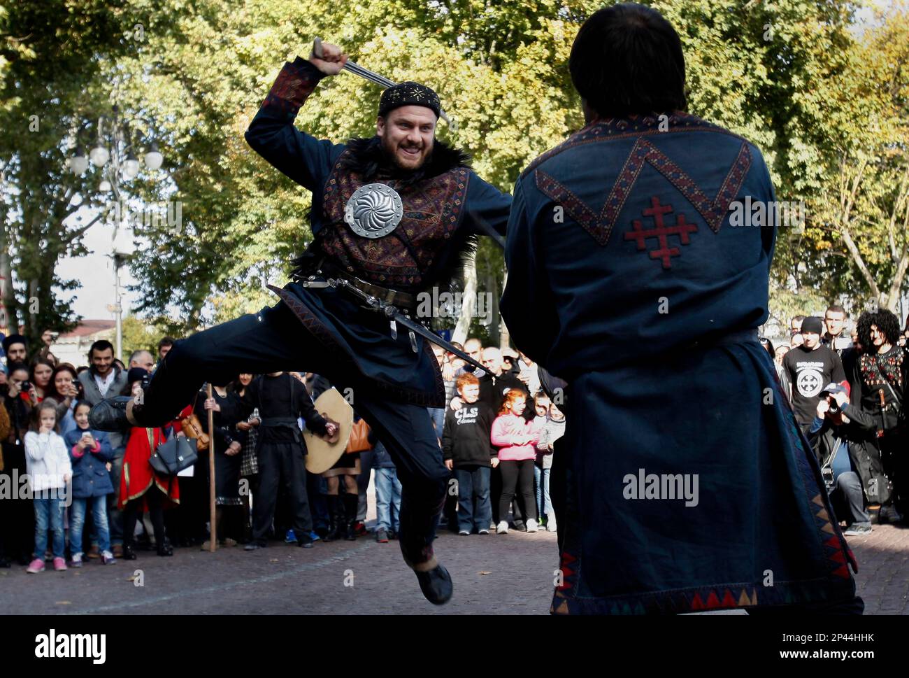 Georgian men in national costumes stage a fight with traditional sabers ...