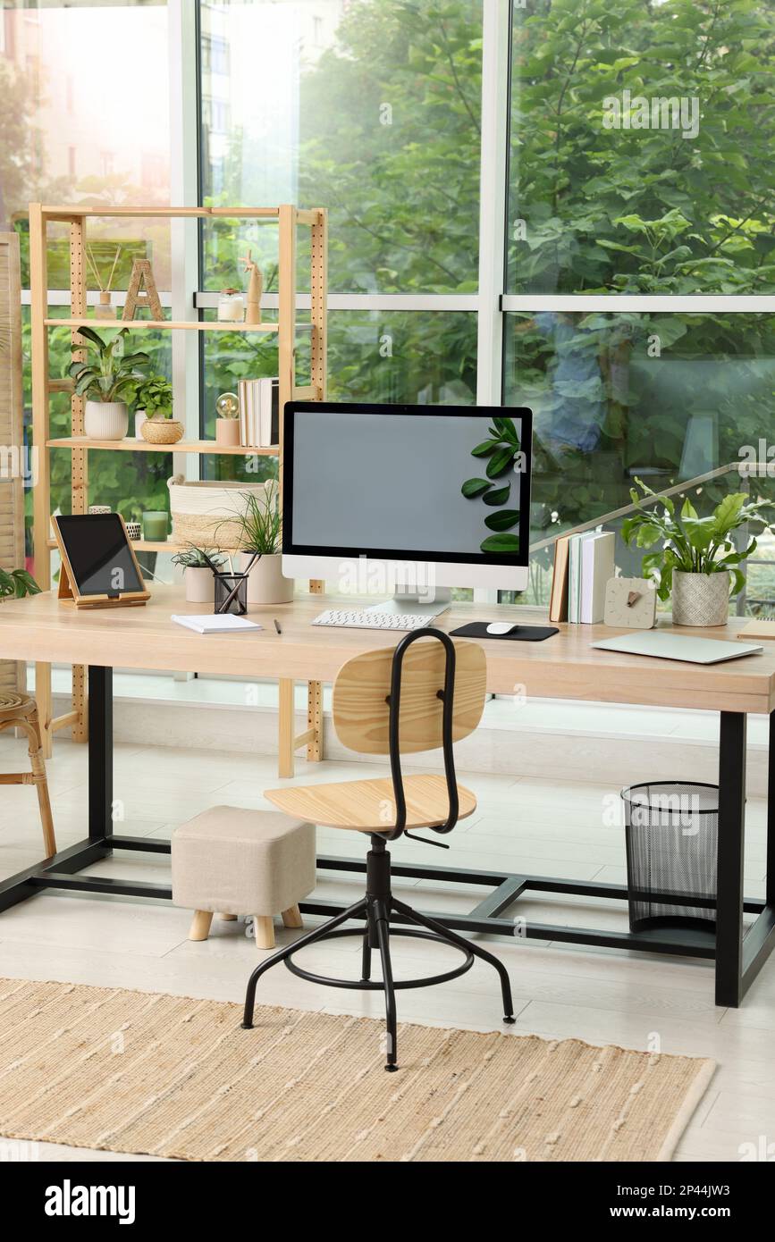Comfortable workplace with computer in light room. Interior design ...