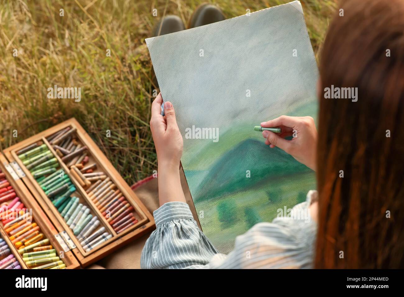 Woman drawing landscape with soft pastels outdoors, closeup Stock Photo ...