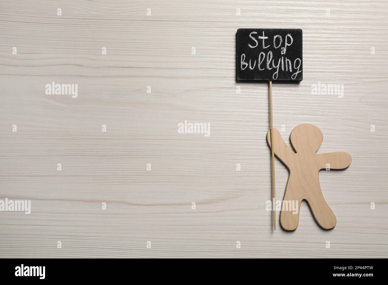 Human figure holding chalkboard with phrase Stop Bullying on white ...