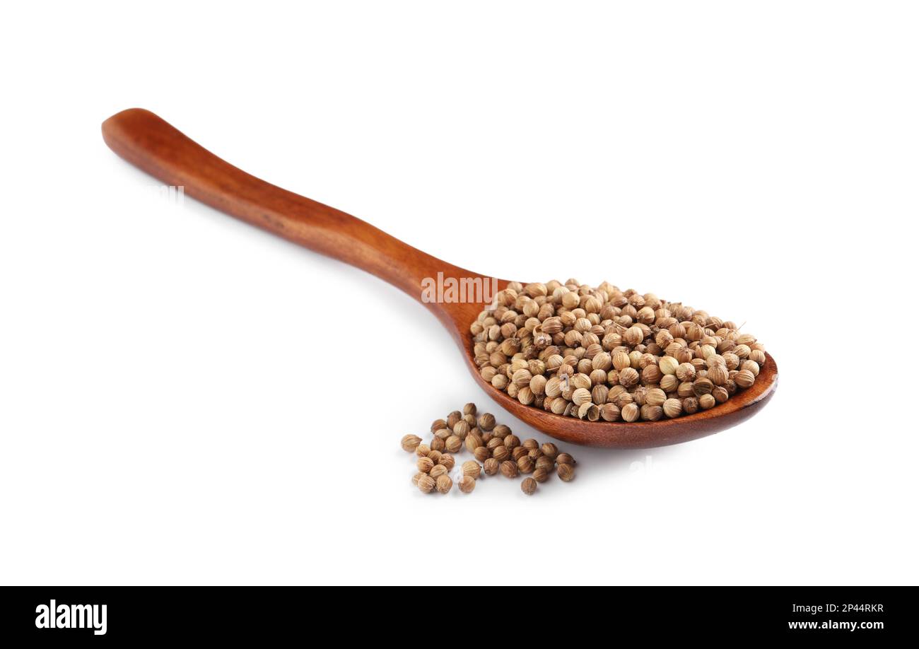 Dried coriander seeds with wooden spoon on white background Stock Photo - Alamy