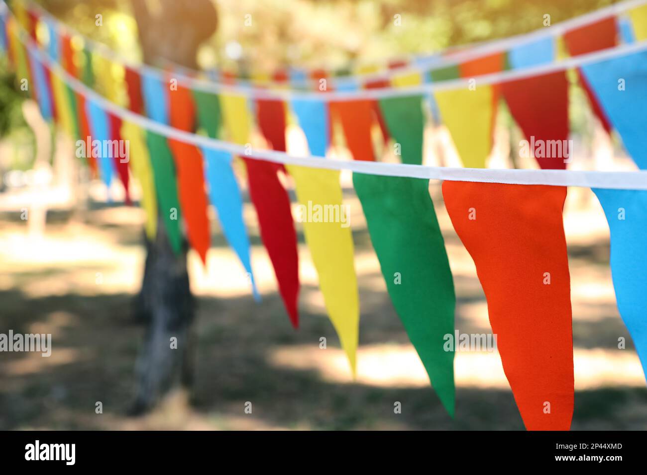 Colorful bunting flags in park. Party decor Stock Photo - Alamy