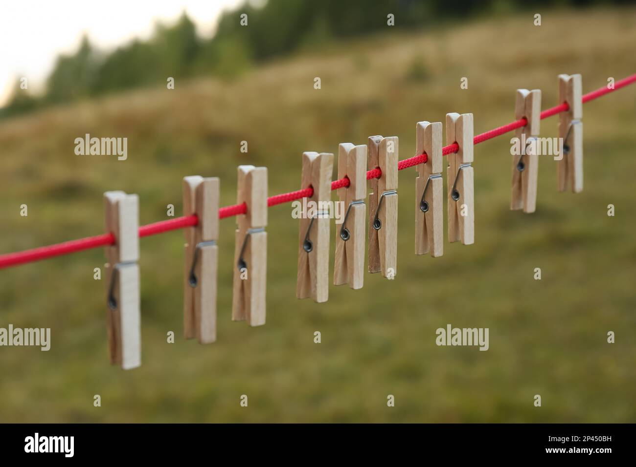 Wooden clothespins hanging on washing line outdoors Stock Photo - Alamy