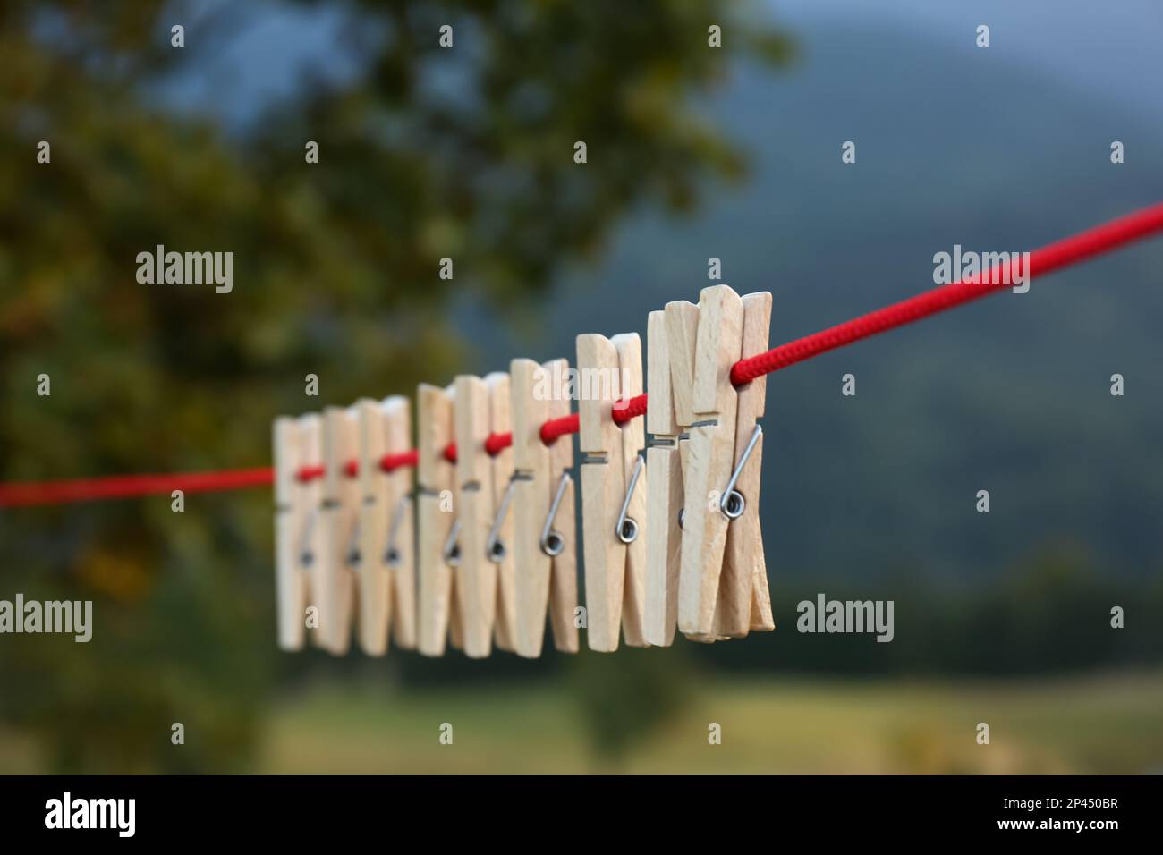 Wooden clothespins hanging on washing line outdoors Stock Photo - Alamy