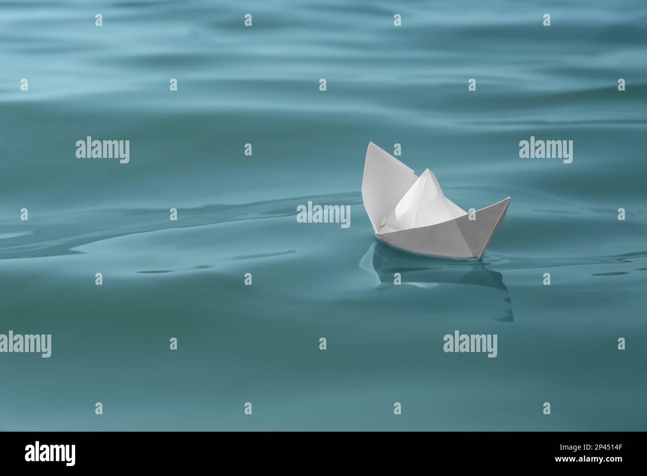 White paper boat floating on water surface, space for text Stock Photo ...