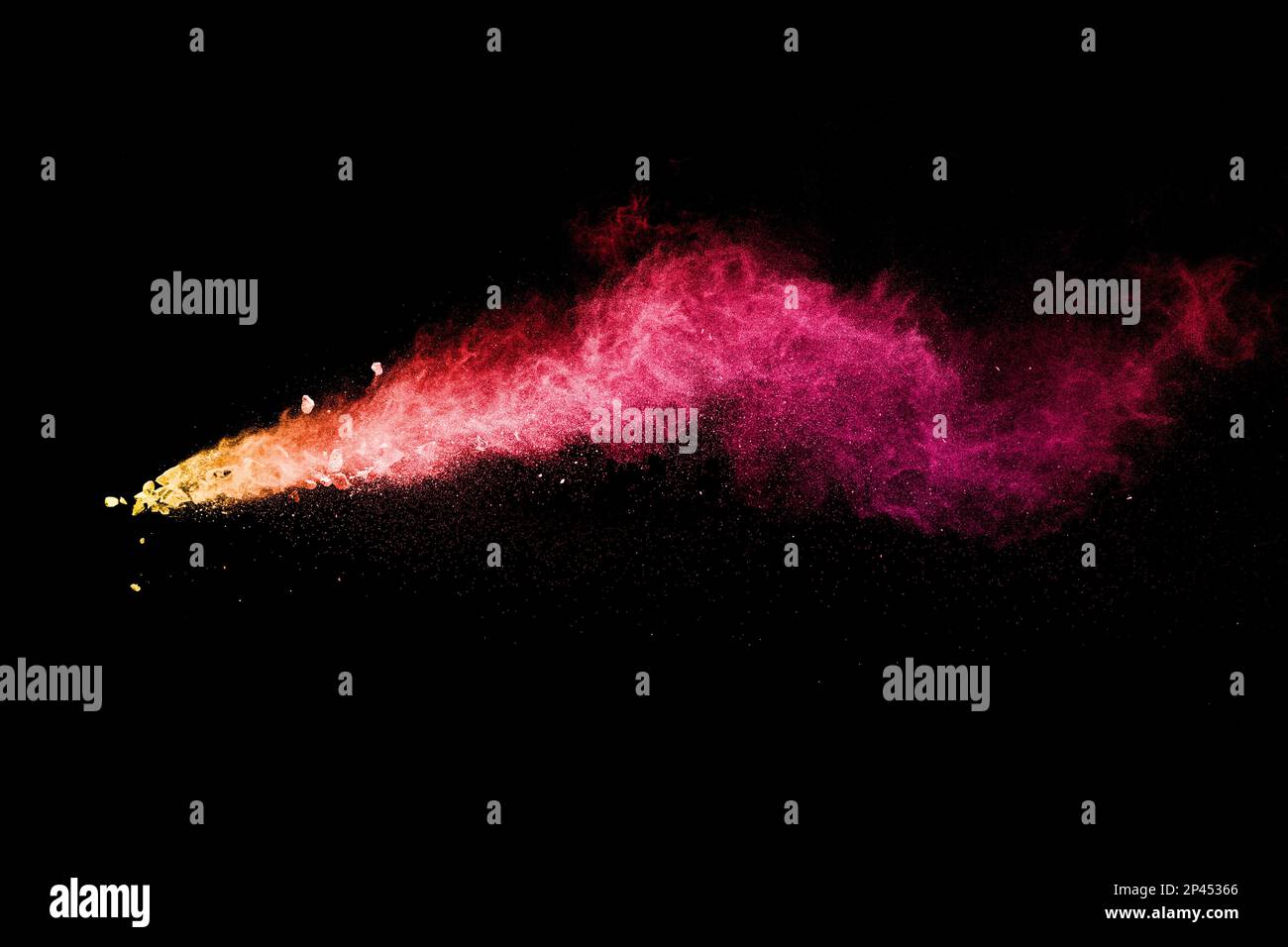 Split debris of stone exploding with red dust against black background ...