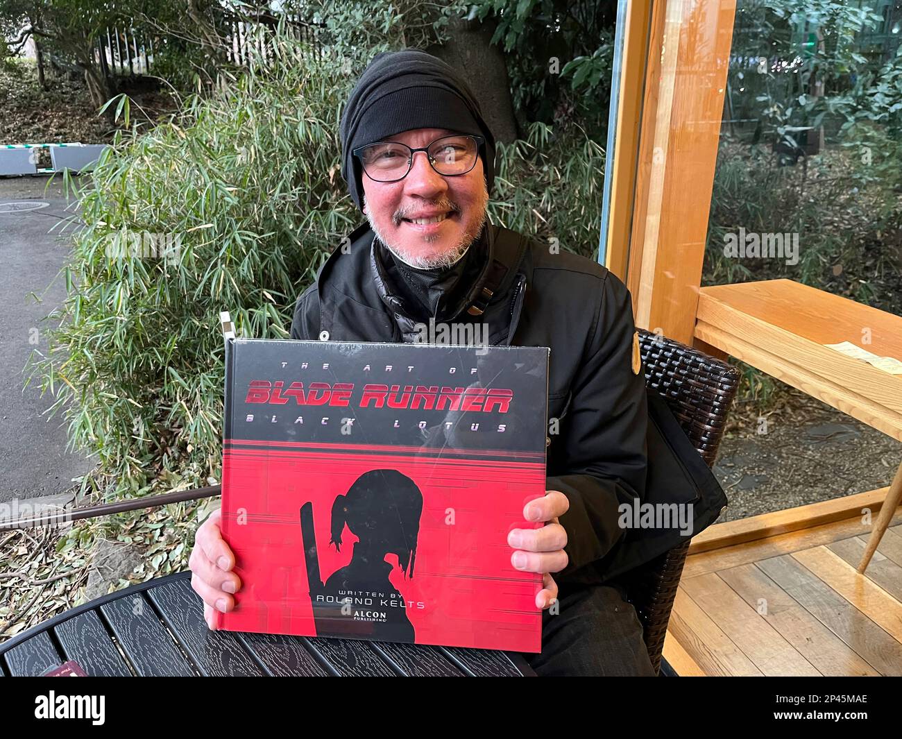Japanese pop culture expert Roland Kelts holds a book about Blade ...