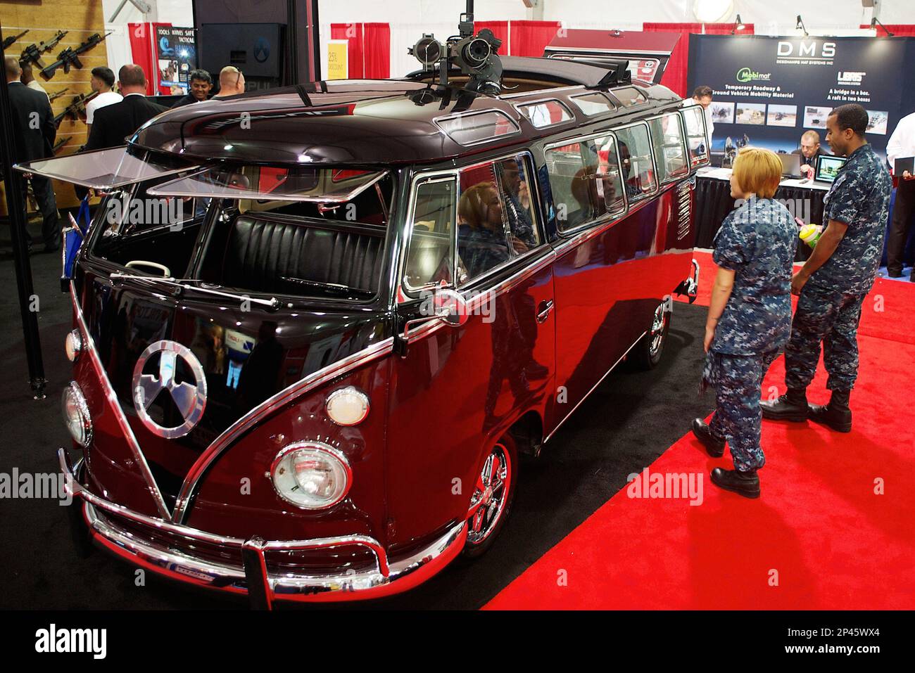 Attendees look at a 1962 Volkswagen microbus outfitted with a Dillon ...