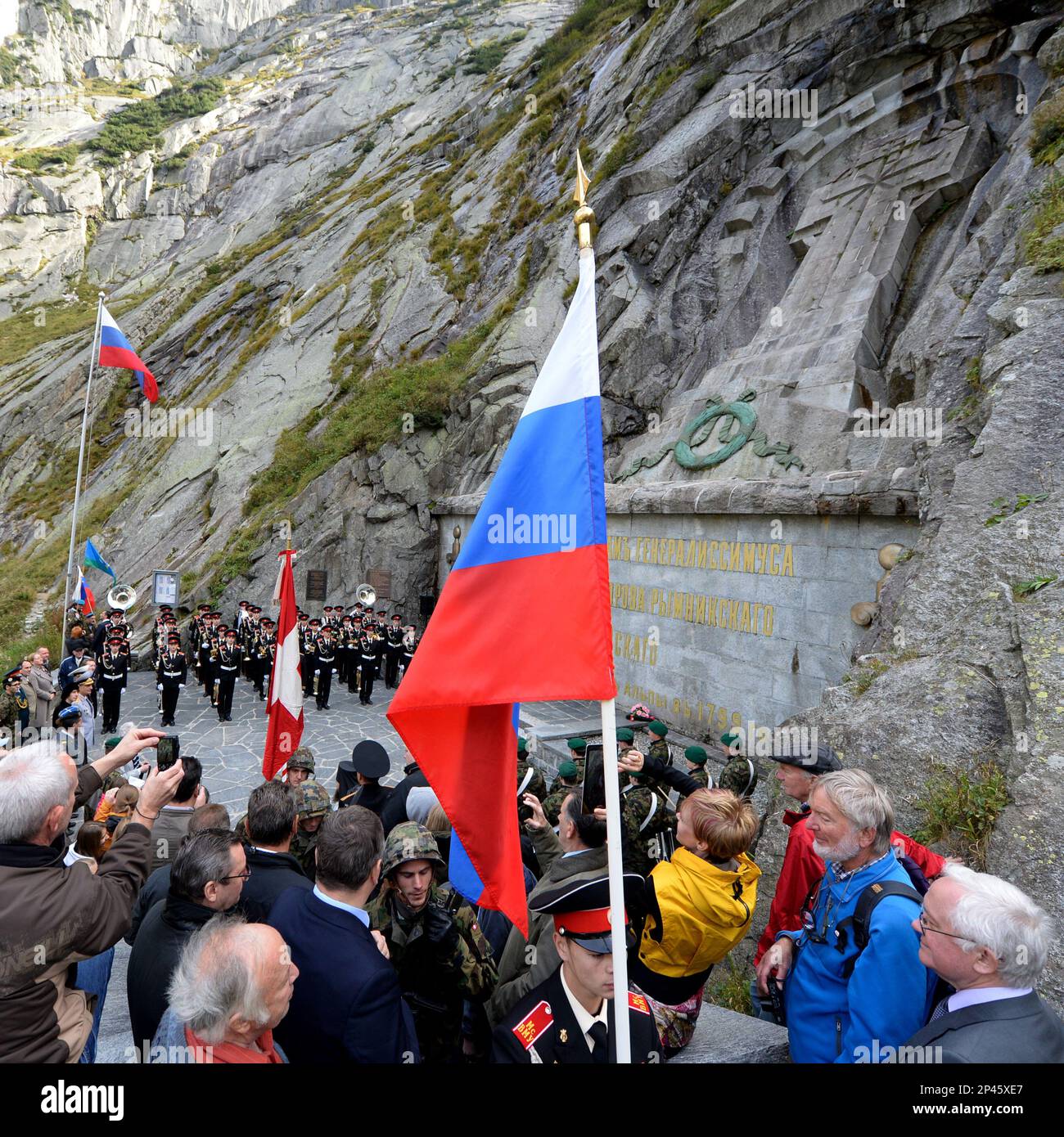 Russian soldiers and audience stand in front of a monument dedicated to ...