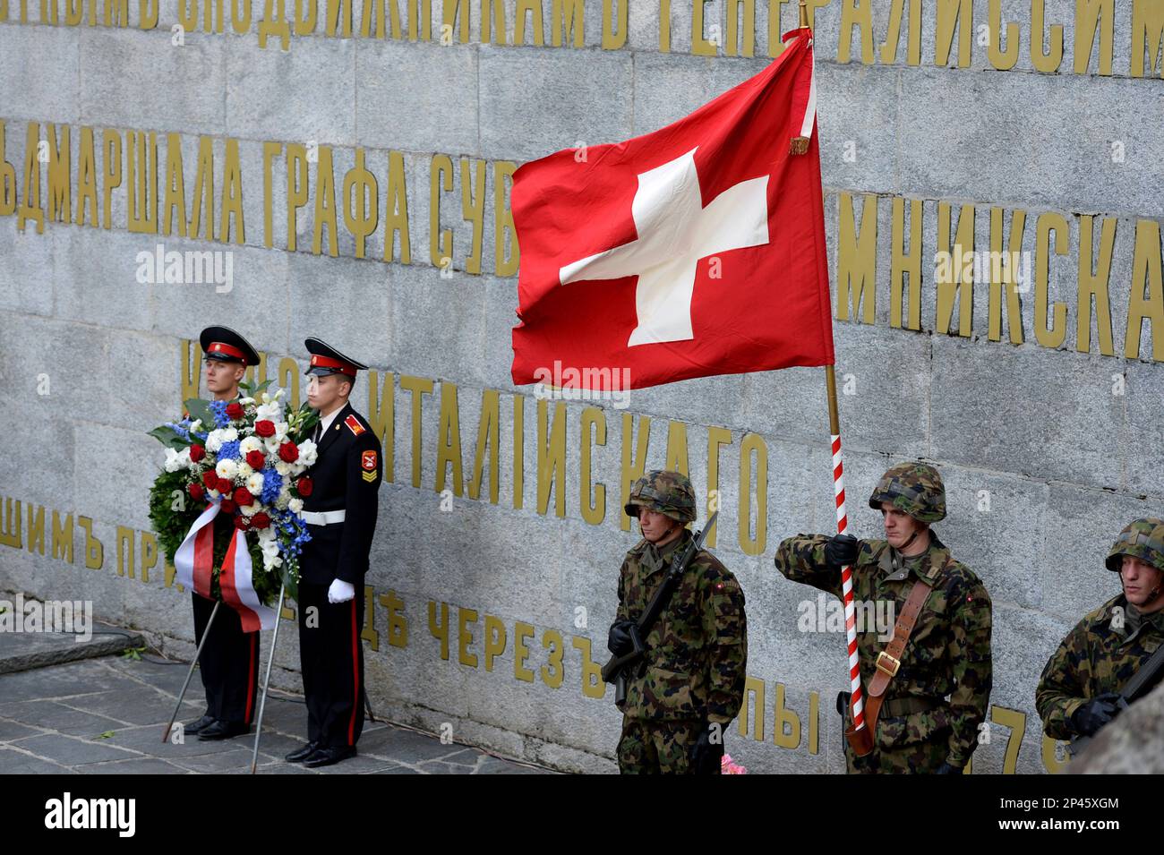 Russian and Swiss soldiers stand in front of a monument dedicated to ...