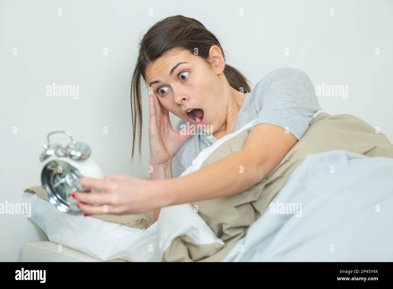 Woman bed shock waking late alarm clock hi-res stock photography and images - Alamy