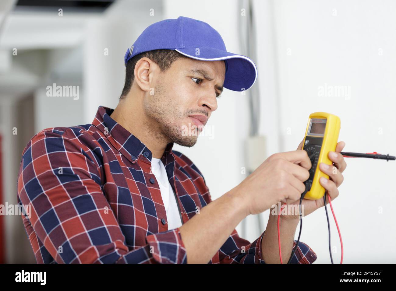 a man checking cables voltage Stock Photo - Alamy