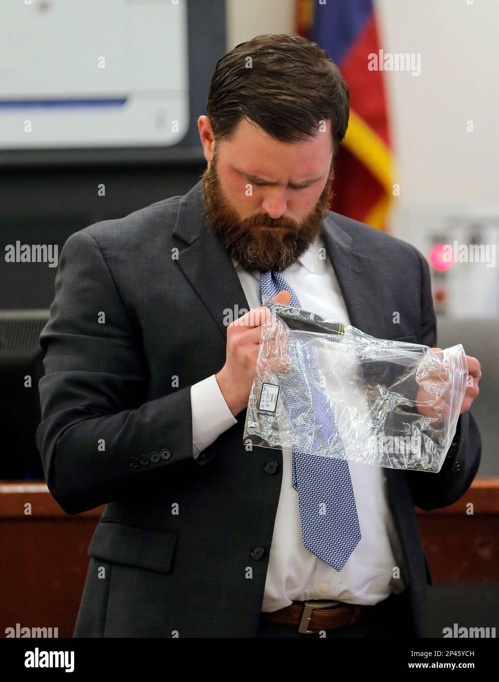 Defense attorney Cody Cofer examines a screwdriver entered as evidence ...
