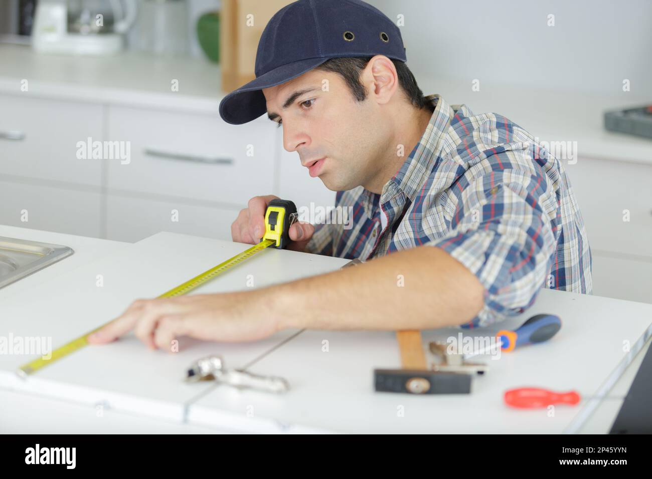 handyman measuring furniture with tape Stock Photo - Alamy