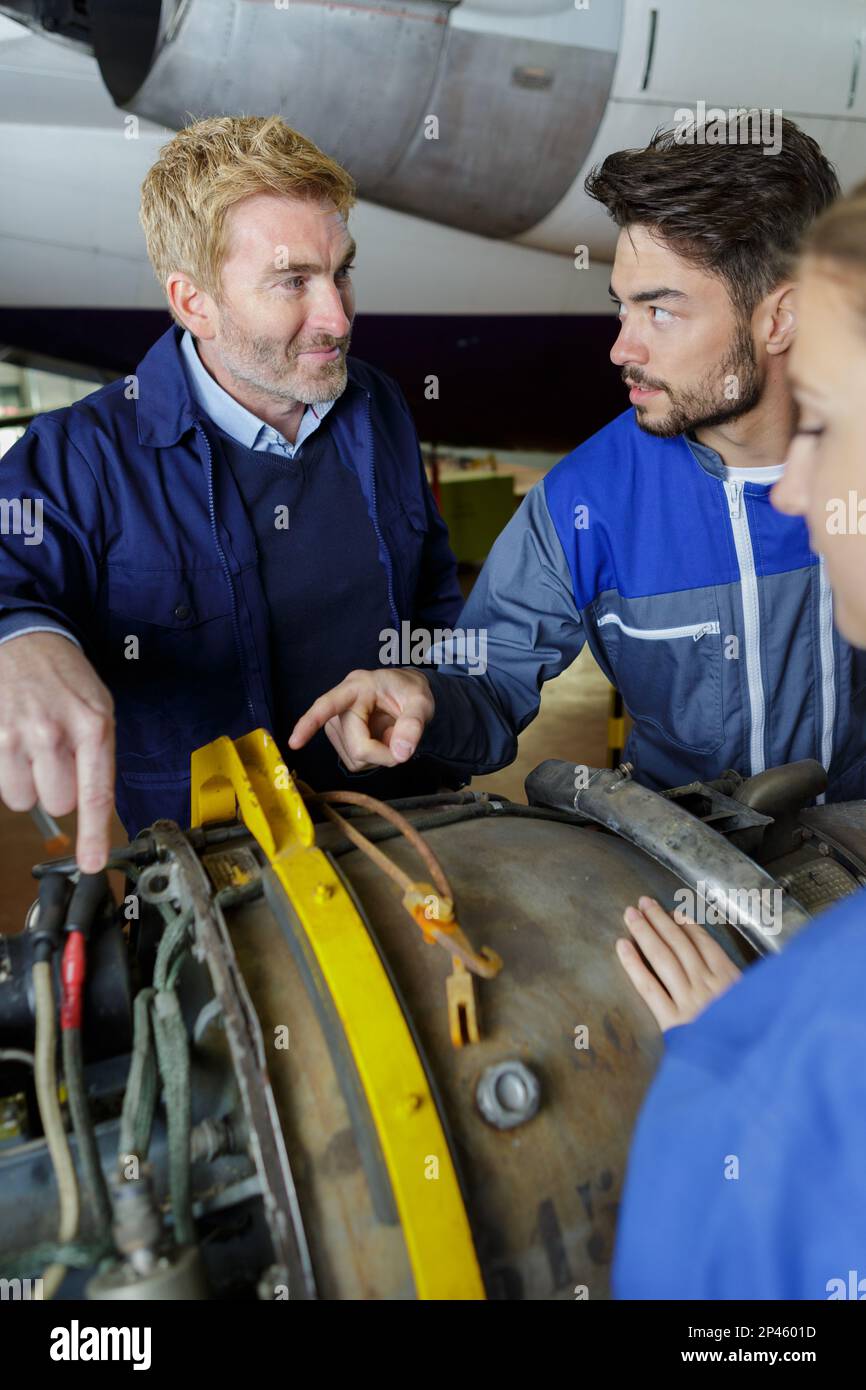 aircraft mechanics repair engine of airplane Stock Photo - Alamy