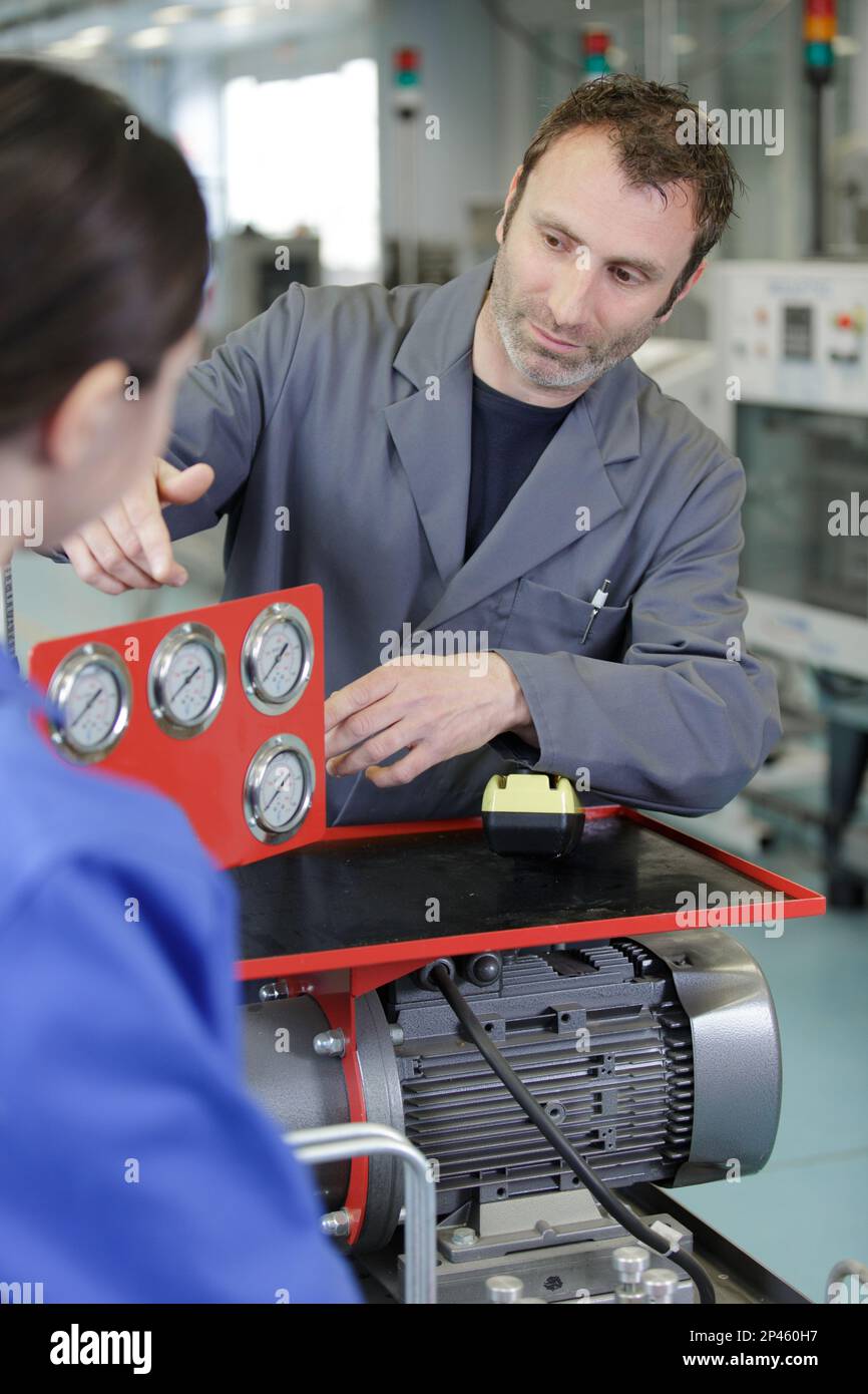 apprentice car mechanics working on an engine Stock Photo - Alamy
