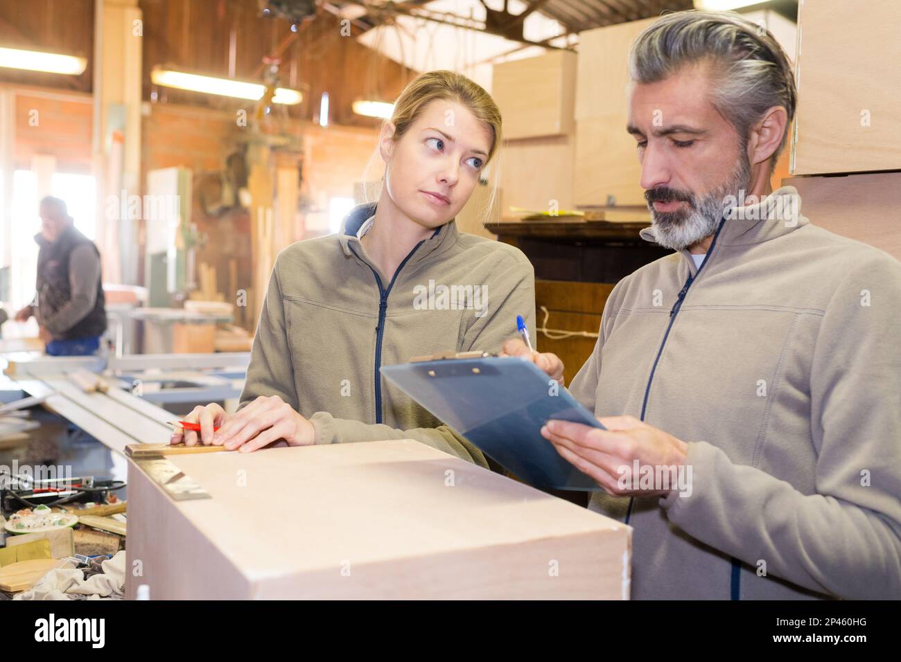 two carpenters talking about process Stock Photo - Alamy