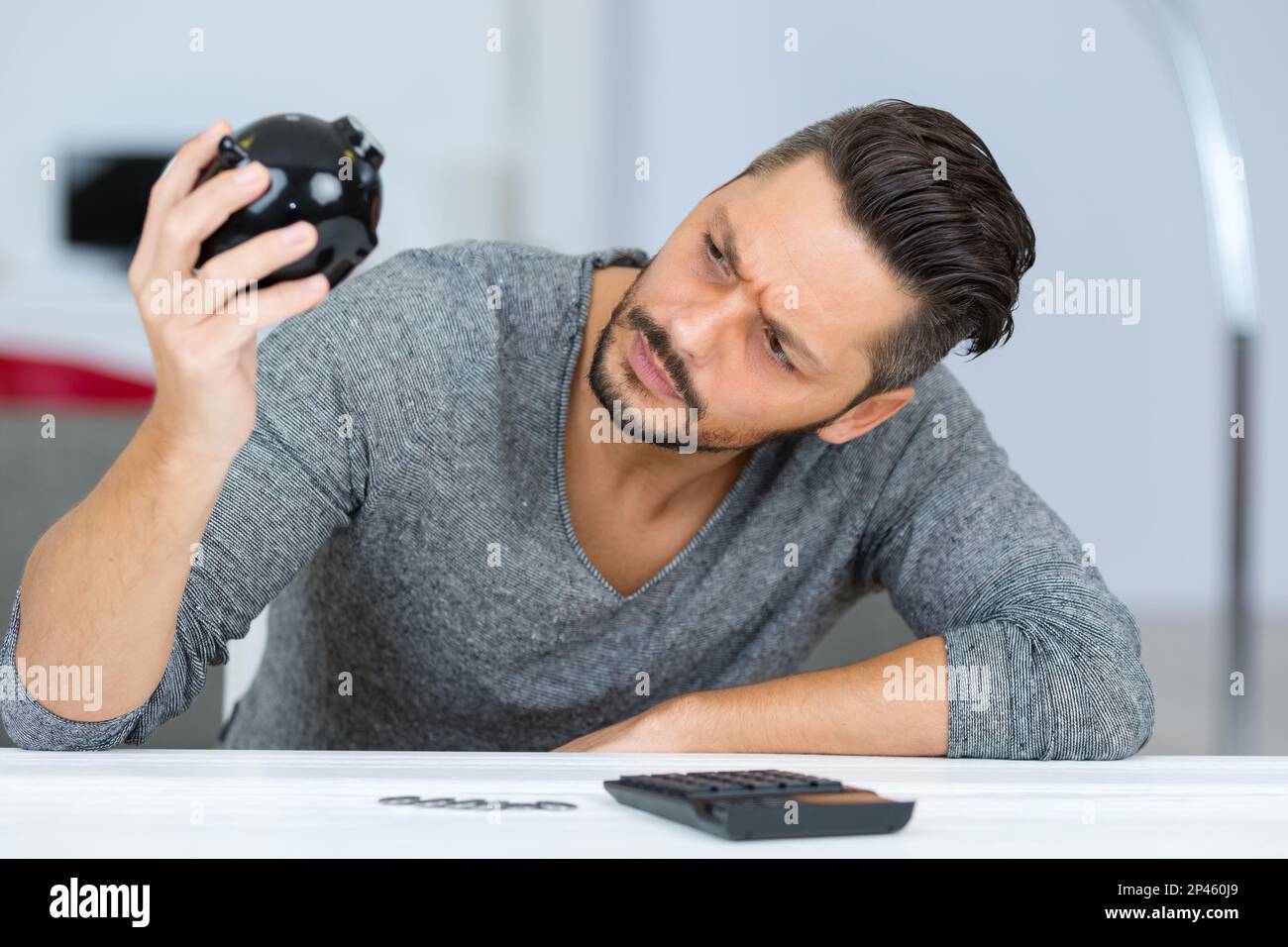 man holding an inspecting an object Stock Photo - Alamy